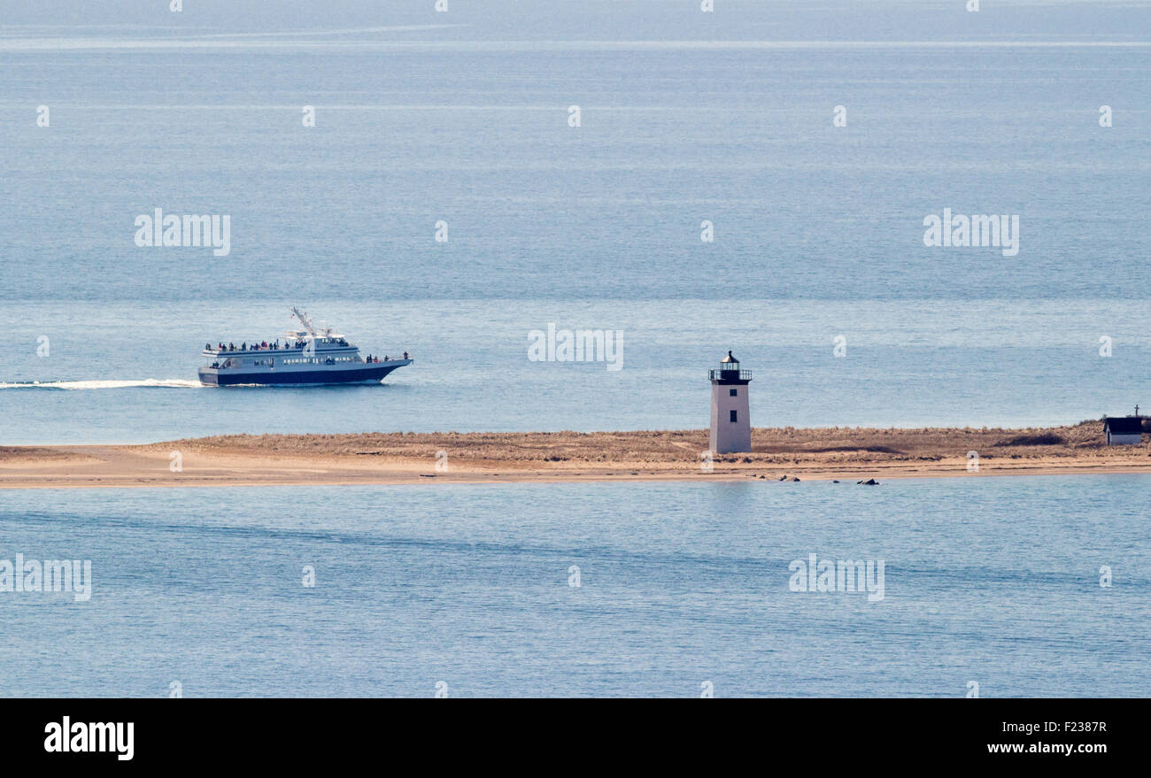 A whale watch boat traveling past a lighthouse to see the whales Stock ...