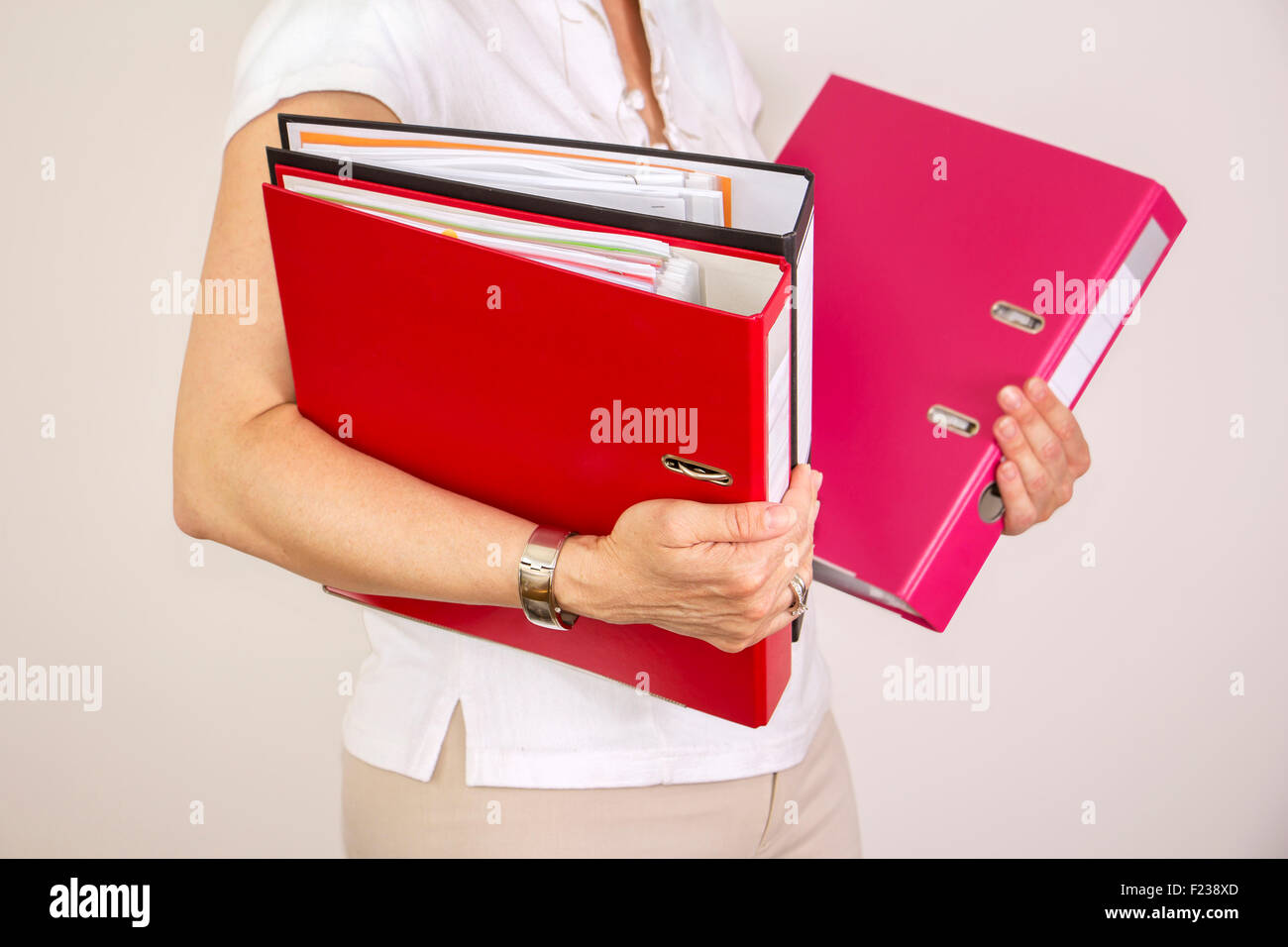 Secretary woman holding stack of office binders Stock Photo - Alamy