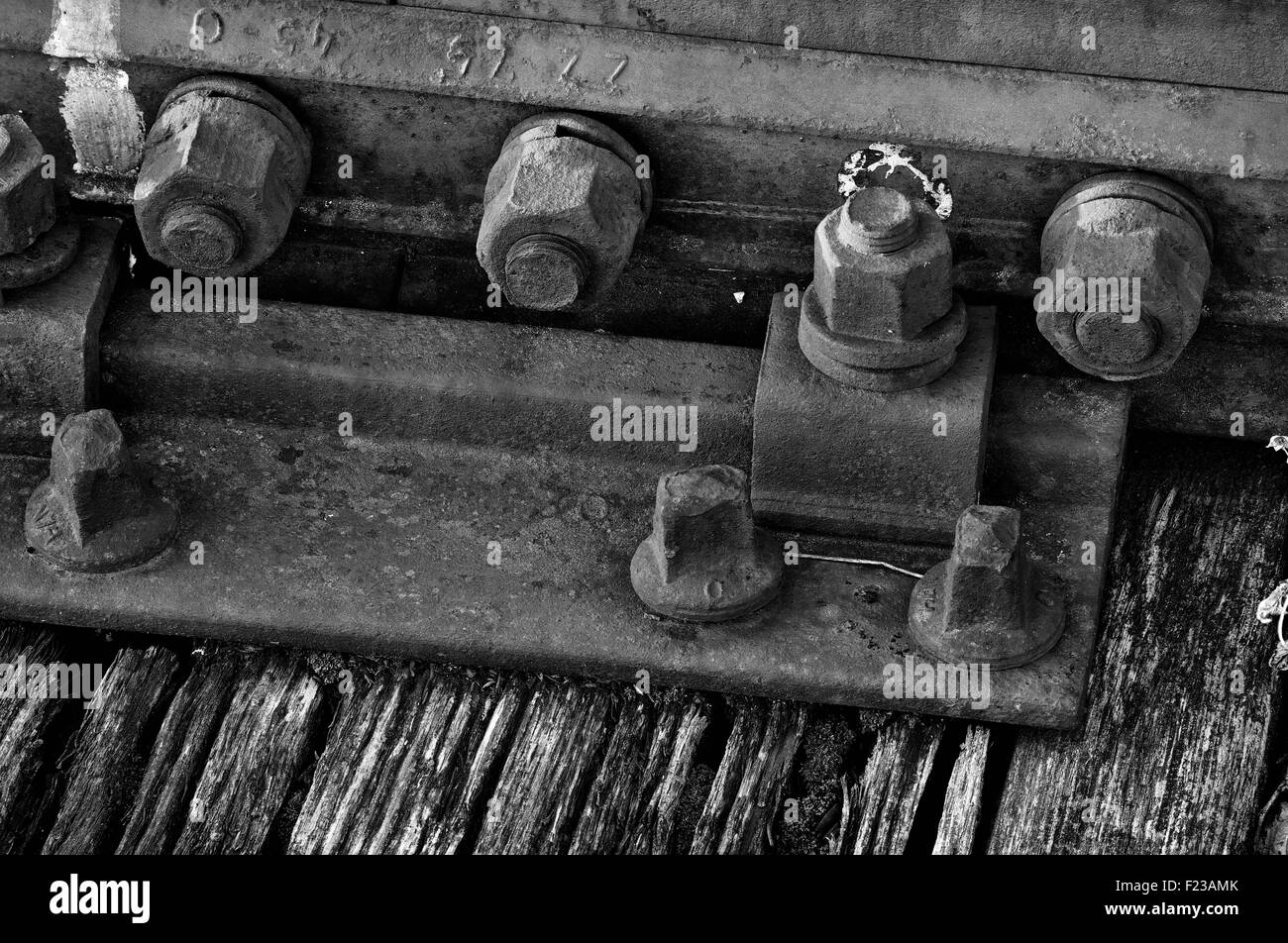 Rusty bolts on a railroad track black and white Stock Photo - Alamy