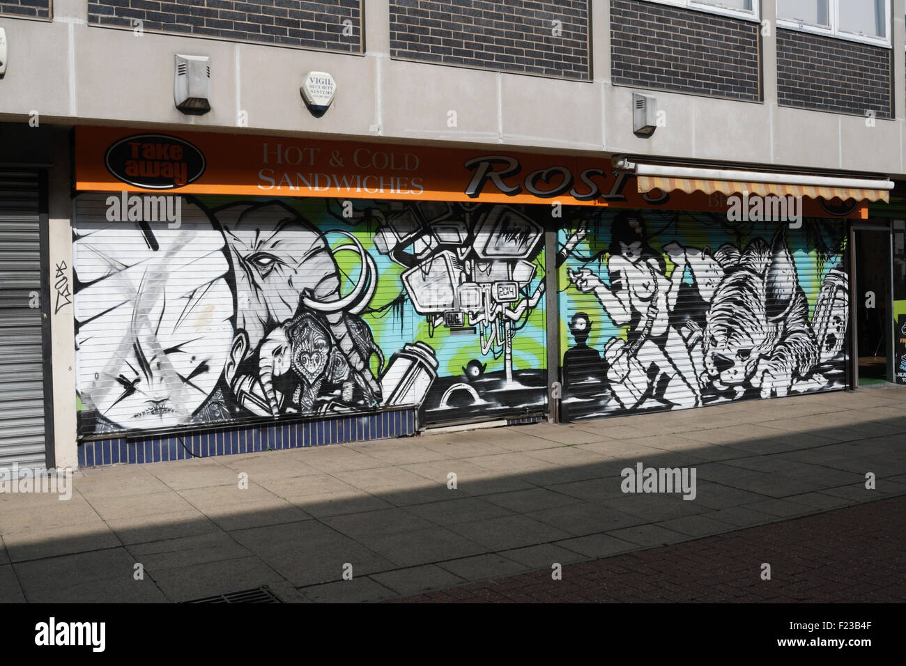 Boarded up shop painted with Grafitti Street Art Stock Photo - Alamy