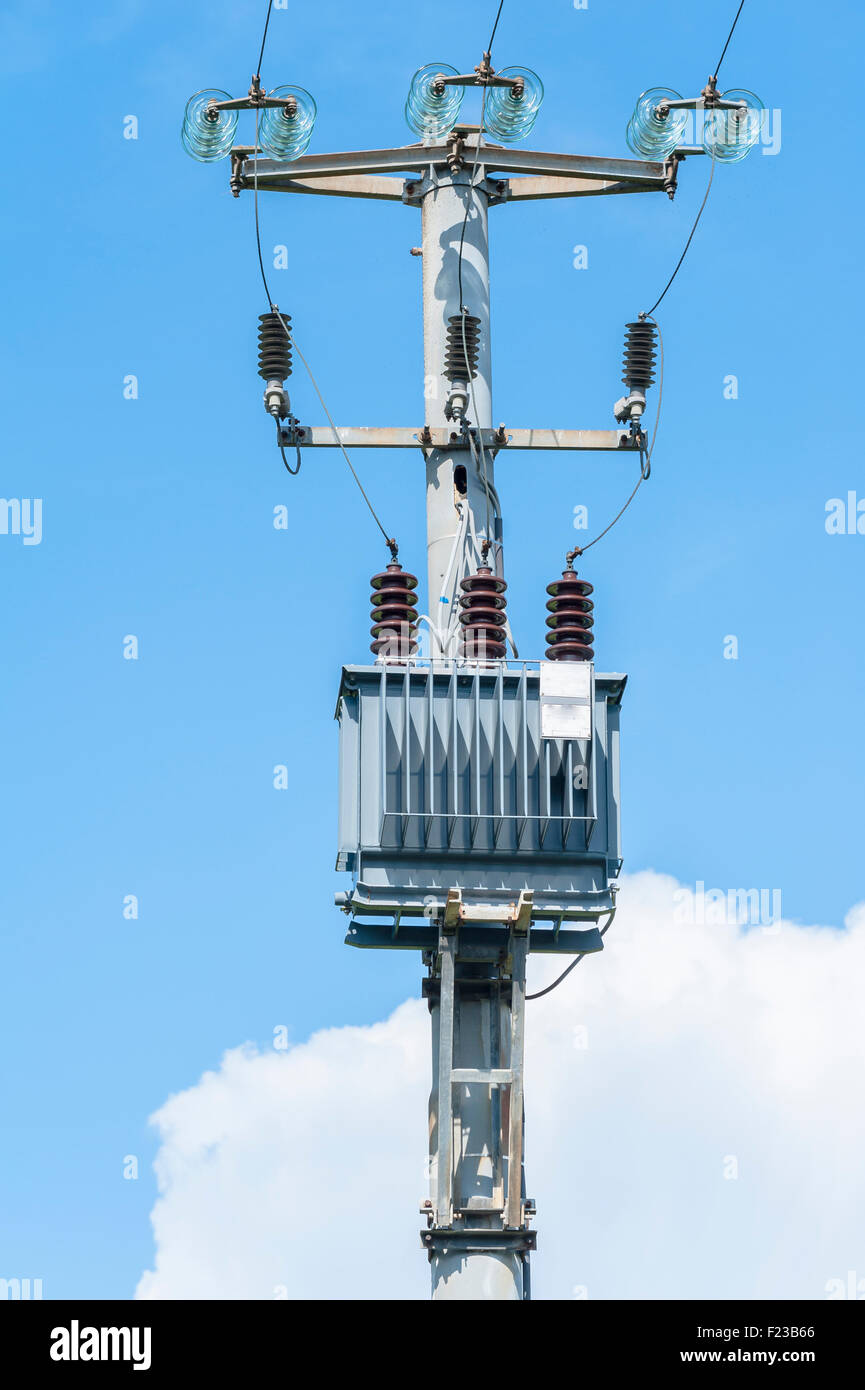 Electrical transformer of electrical pylon against the blue sky Stock ...