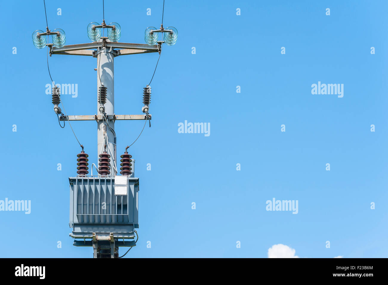 Electrical transformer of electrical pylon against the blue sky Stock ...
