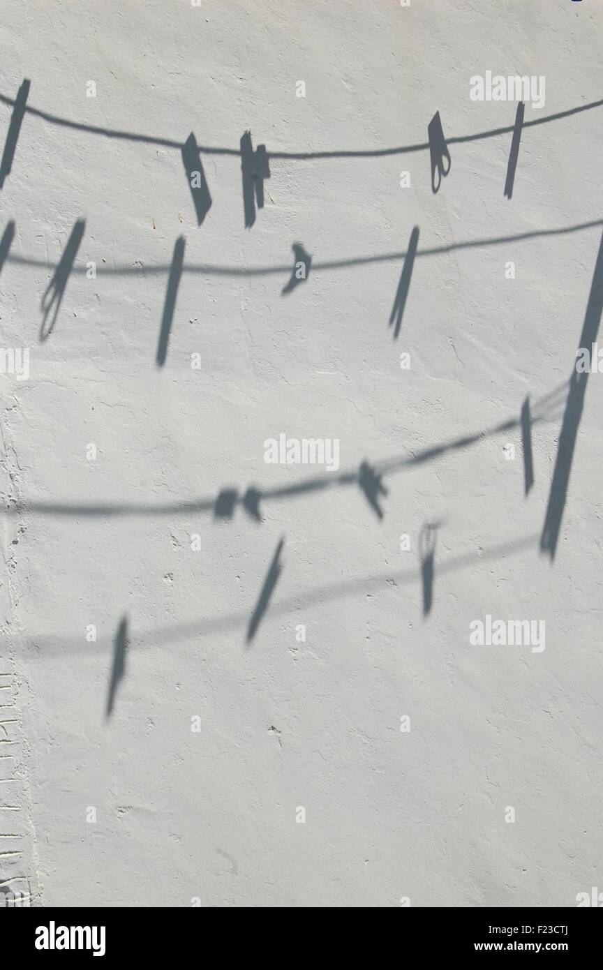 Shadows of pegs on washing lines on a white wall Stock Photo - Alamy