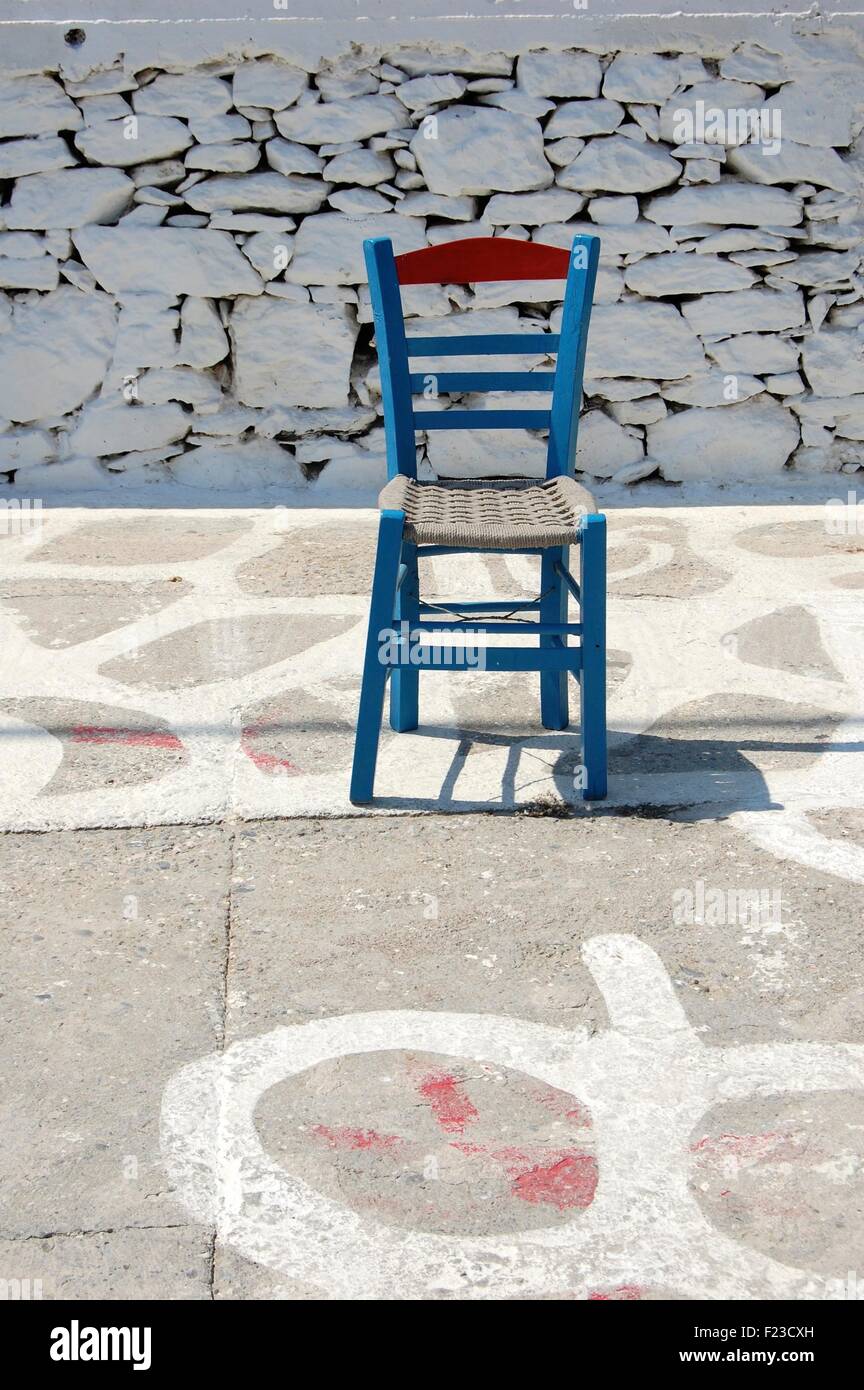single blue chair in katapola on amorgos greece Stock Photo - Alamy