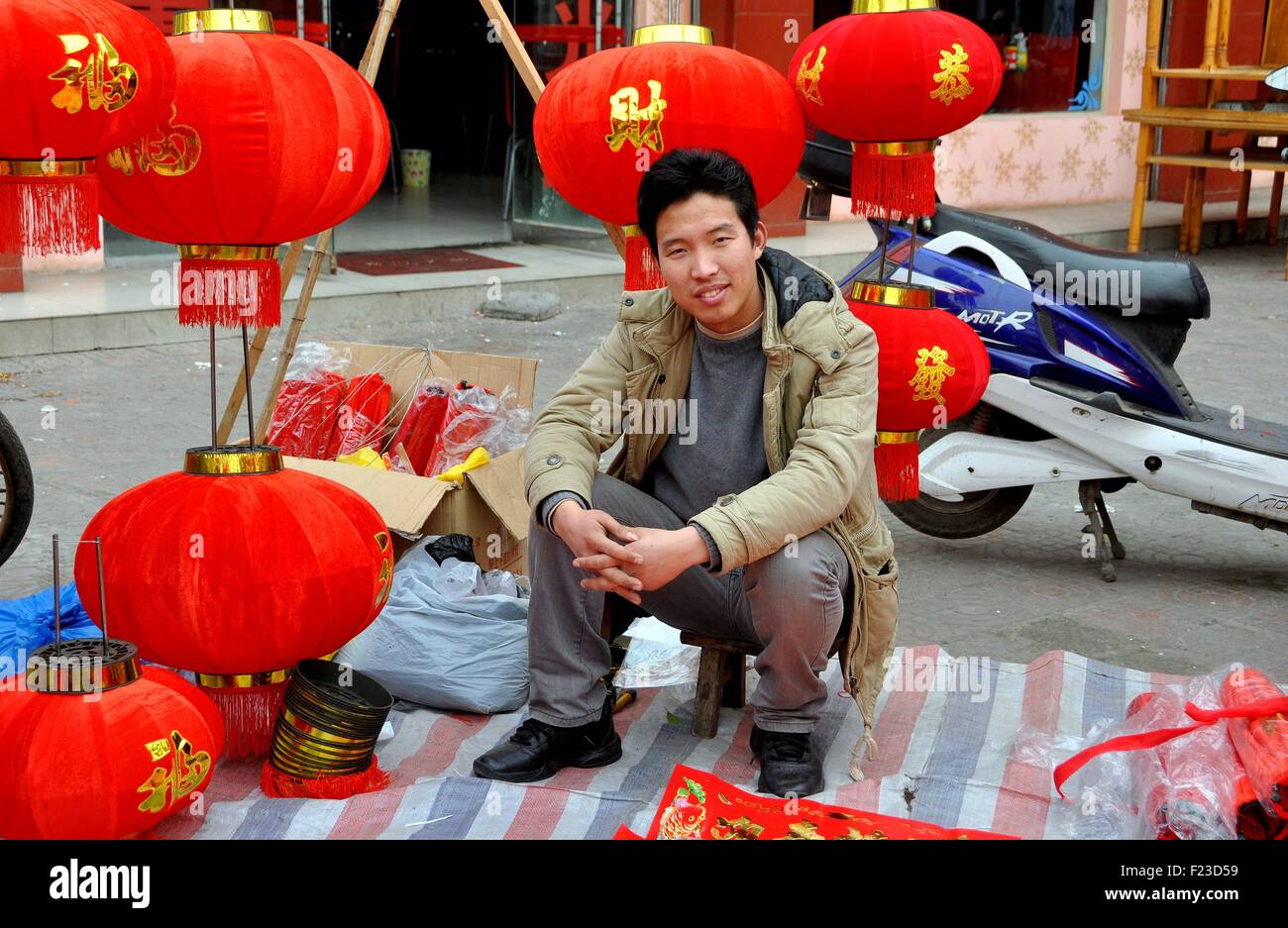 Pengzhou, China: Young man selling Chinese Lunar New Year decorations ...