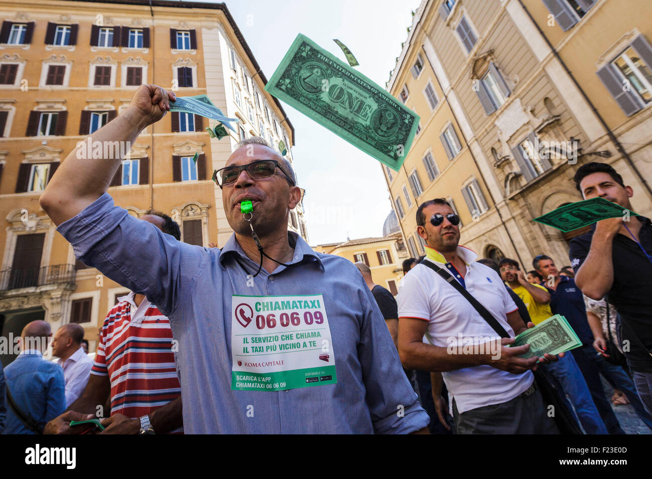 An Italian taxi driver blows a whistle as he take part in a ...