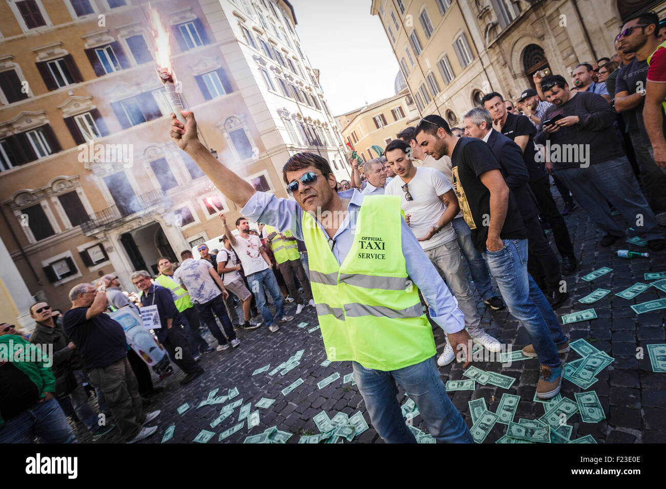 An Italian taxi driver lights a flare as he take part in a ...