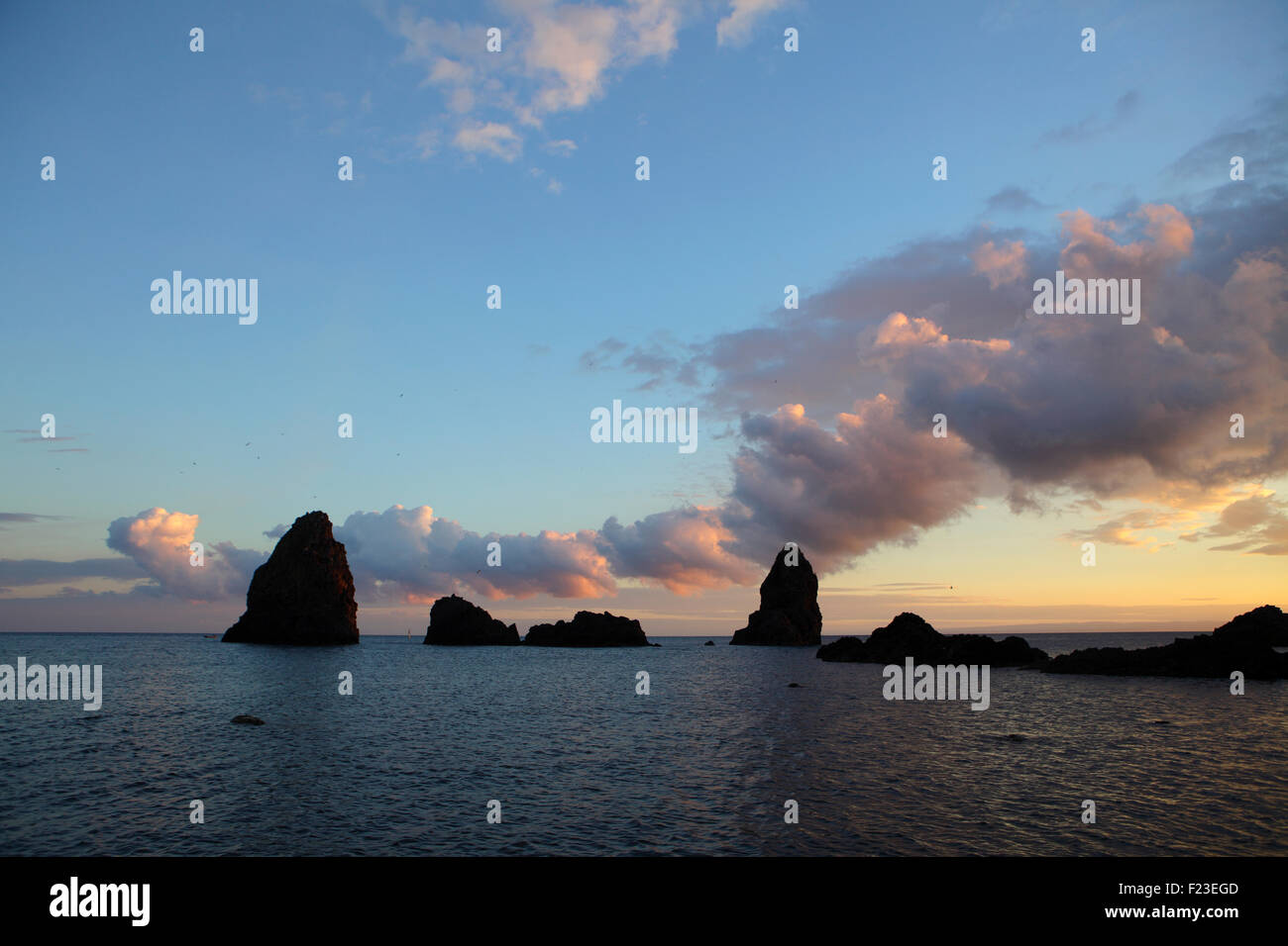Cyclops stacks in Aci Trezza at sunrise, Sicily, Italy Stock Photo - Alamy