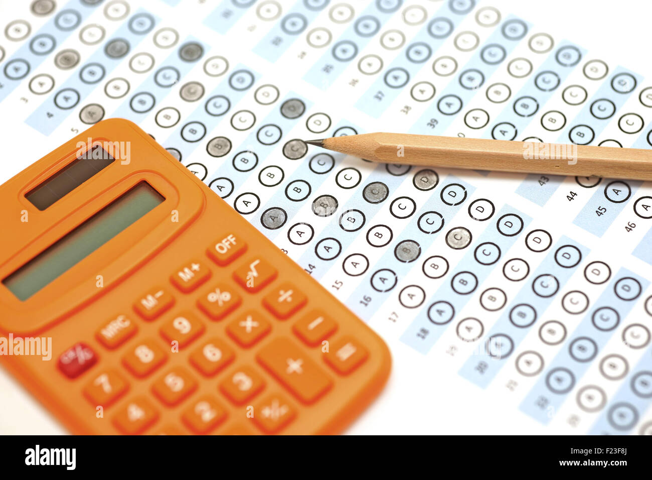 answer sheet test score with pencil and orange calculator Stock Photo ...