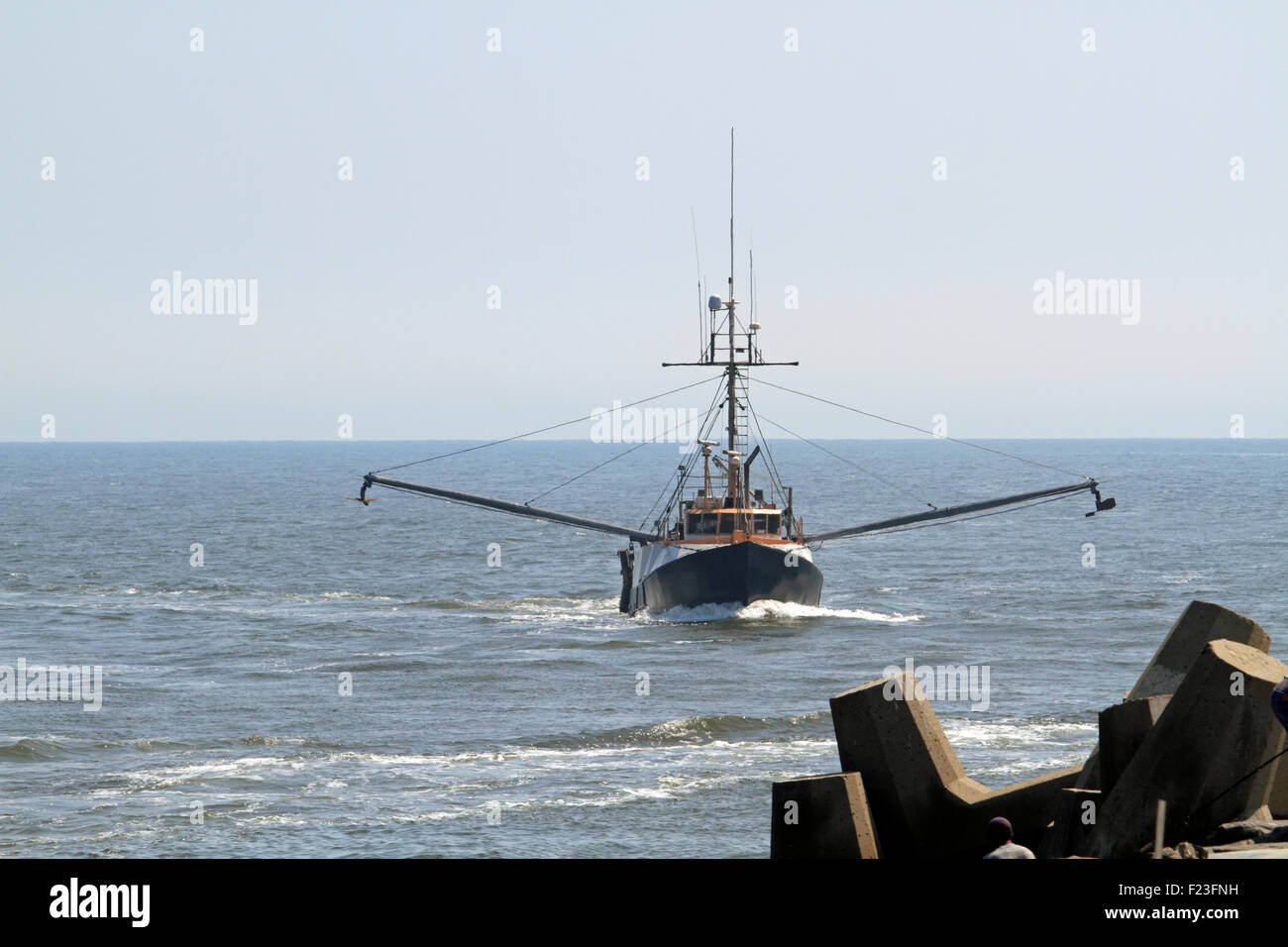 A commercial fishing trawler returning from work and about to enter the ...