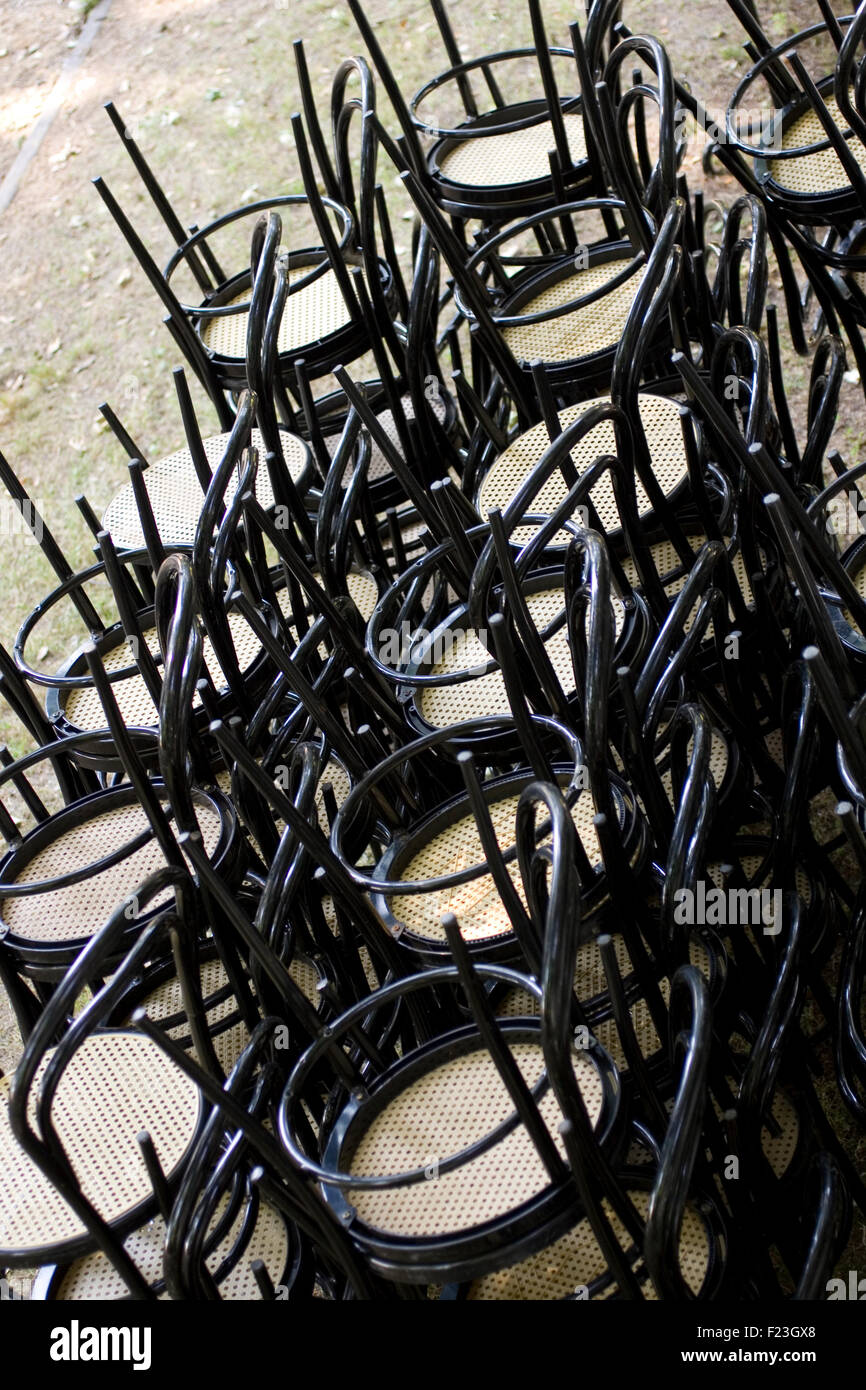 Photo of stacked black chairs Stock Photo - Alamy