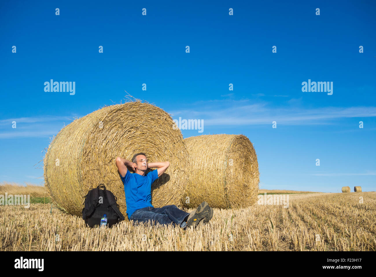 Mature walker resting on The Cleveland Way coastal path on cliffs near ...