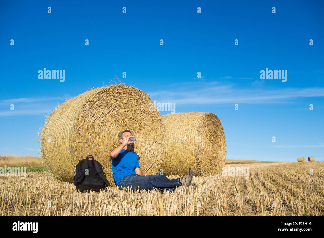 Mature walker resting on The Cleveland Way coastal path on cliffs near ...