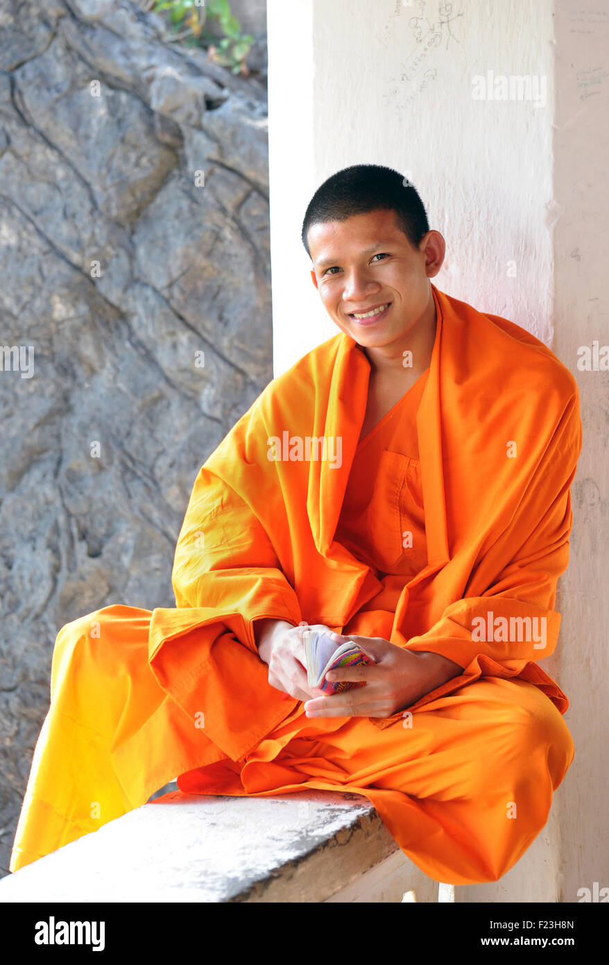 Lao monk reading from a language book, Luang Prabang, Laos Stock Photo ...