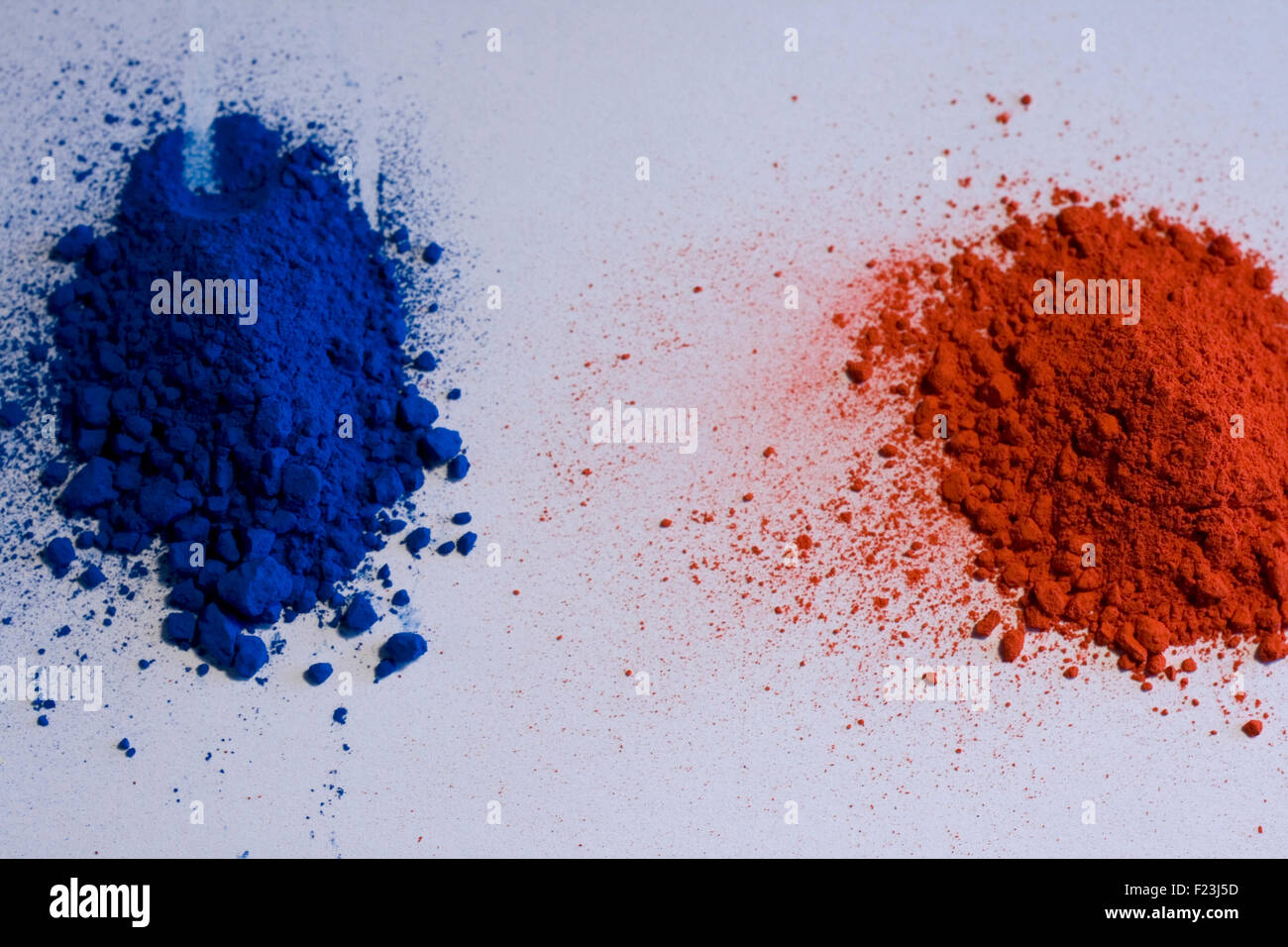 Red and blue pigments on a white backround Stock Photo - Alamy