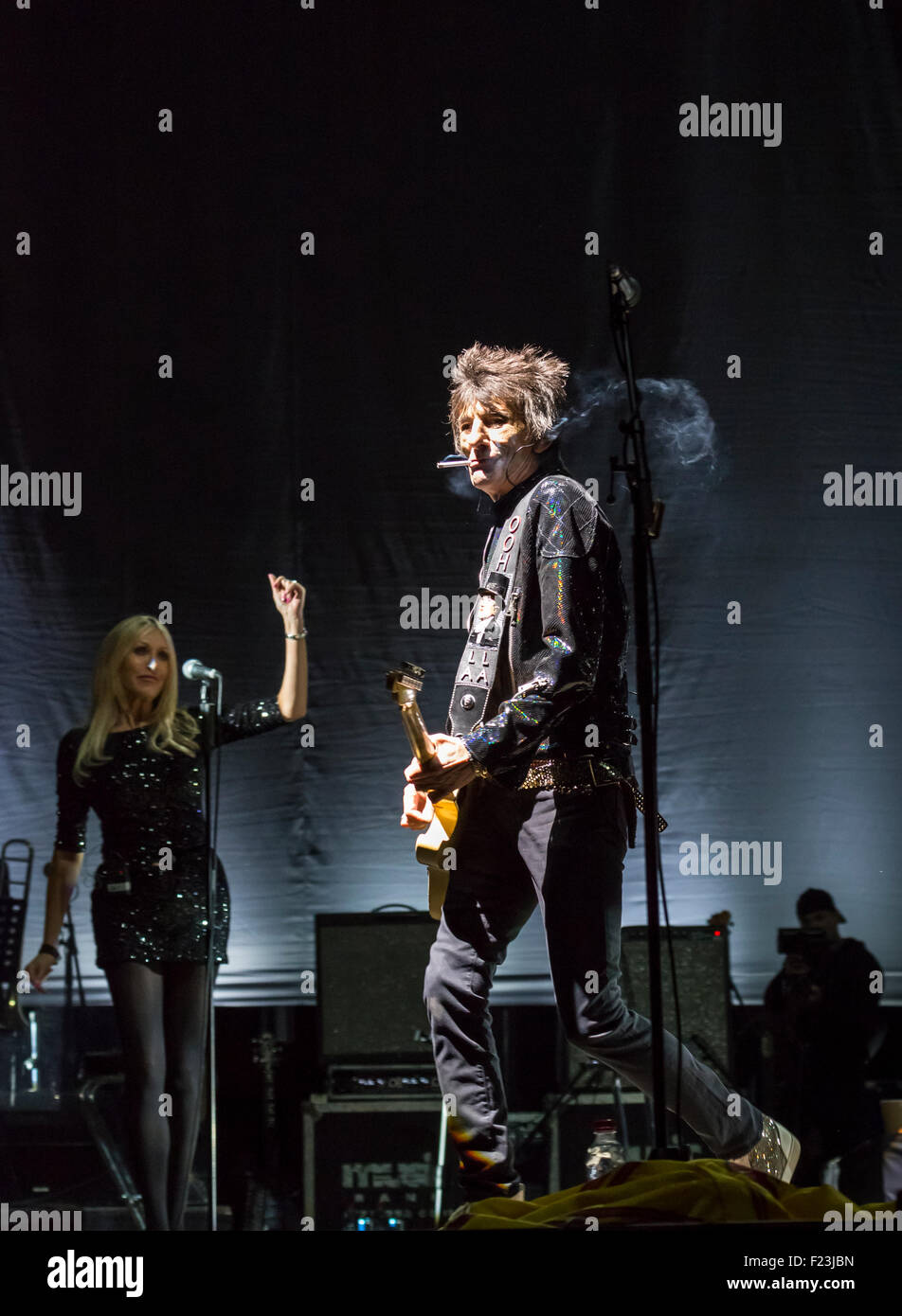 Ronnie Wood smoking, playing guitar with The Faces reunited, performing ...