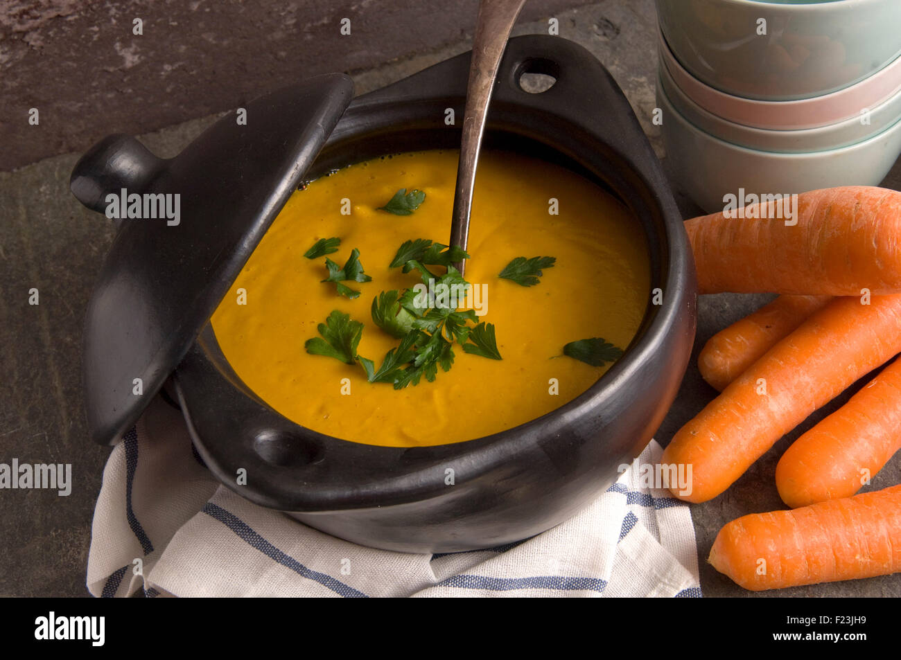 Carrot soup, a vegetarian meal in a deep bowl, often served as a a ...