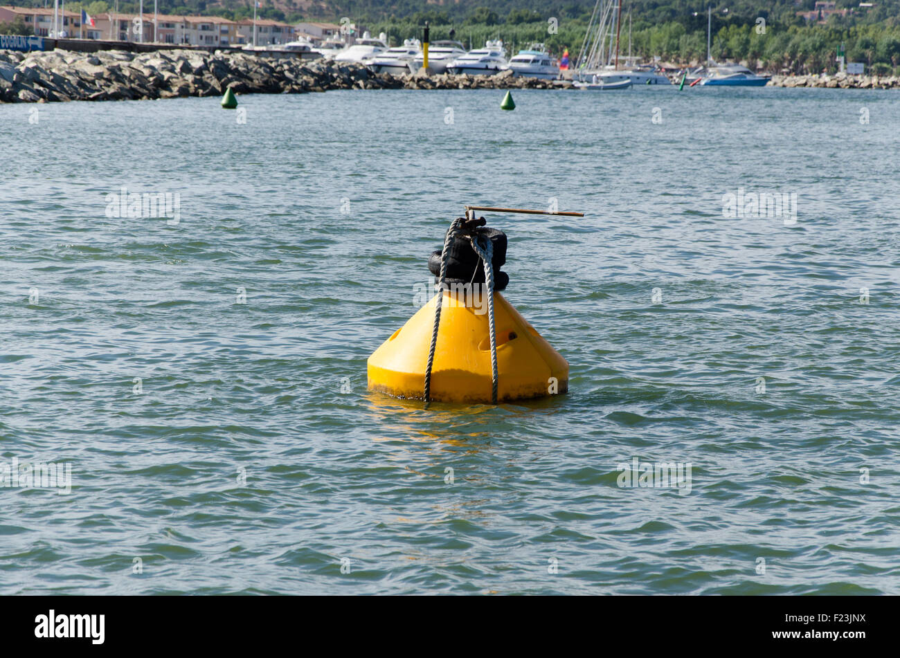 A yellow buoy floating on a sea Stock Photo - Alamy