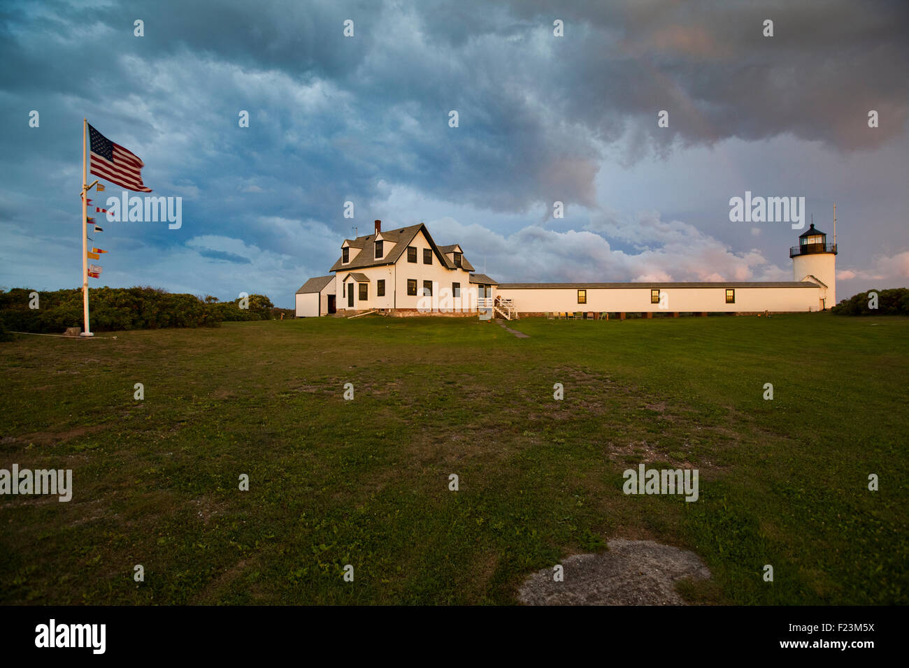 Goat Island Lighthouse bathed in evening light with storm clouds ...