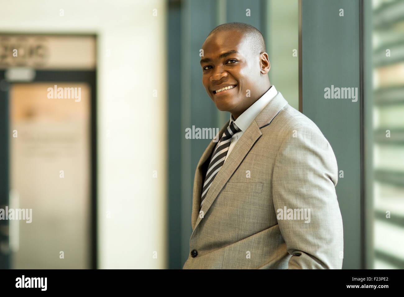 handsome young black businessman in modern office Stock Photo - Alamy