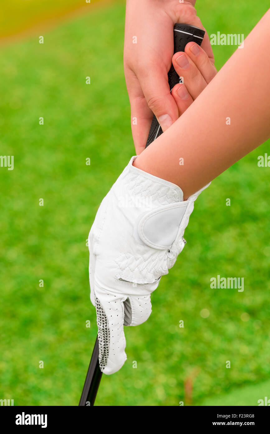 hand with white gloves holding golf a putter Stock Photo - Alamy