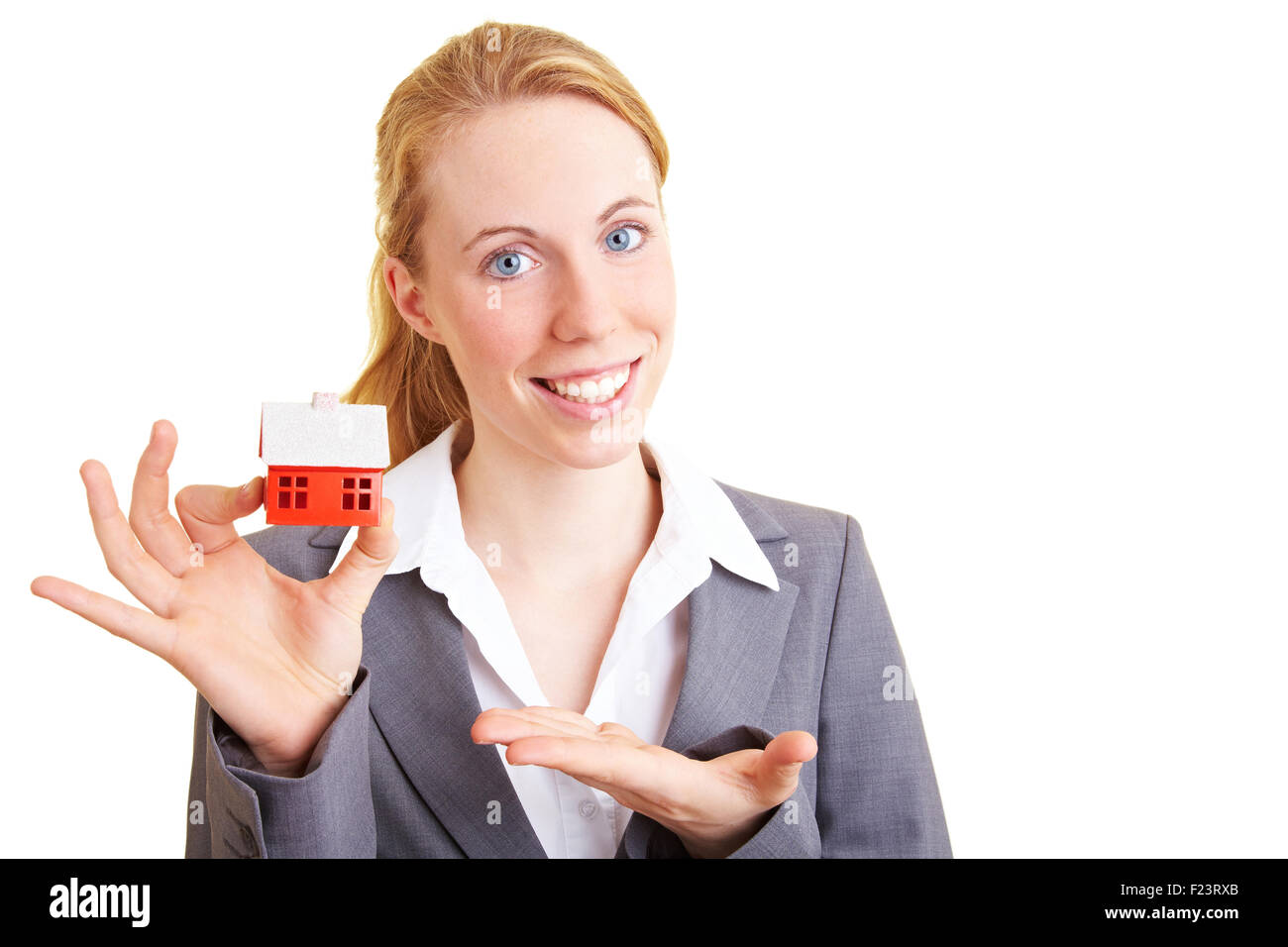 Real estate broker holding a miniature house Stock Photo - Alamy