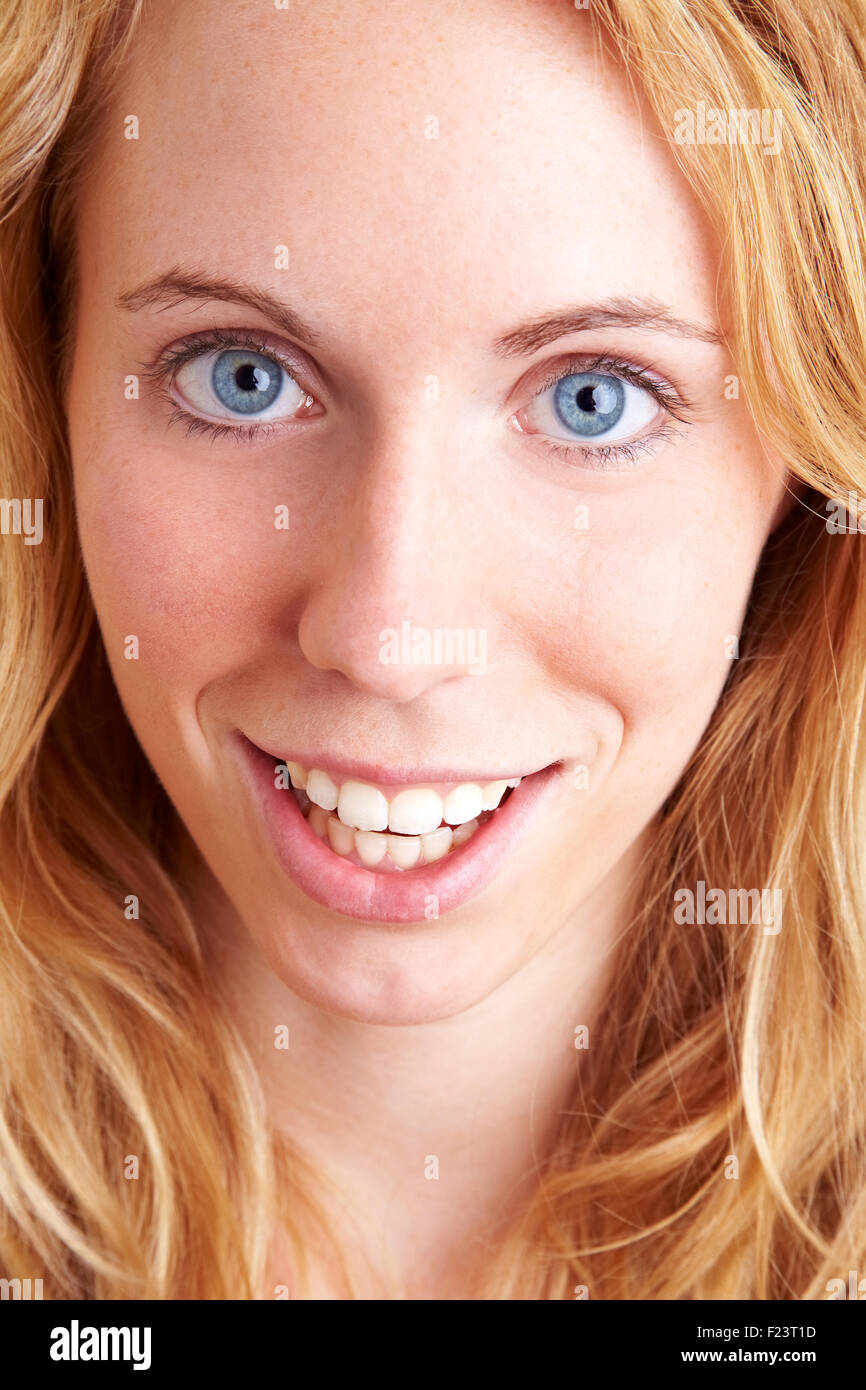 Young blond woman smiling into the camera Stock Photo - Alamy
