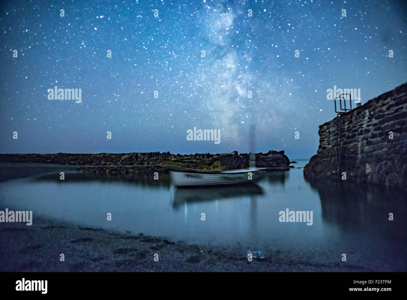 The Milkyway and night sky over the harbour at Portwrinkle in Cornwall ...