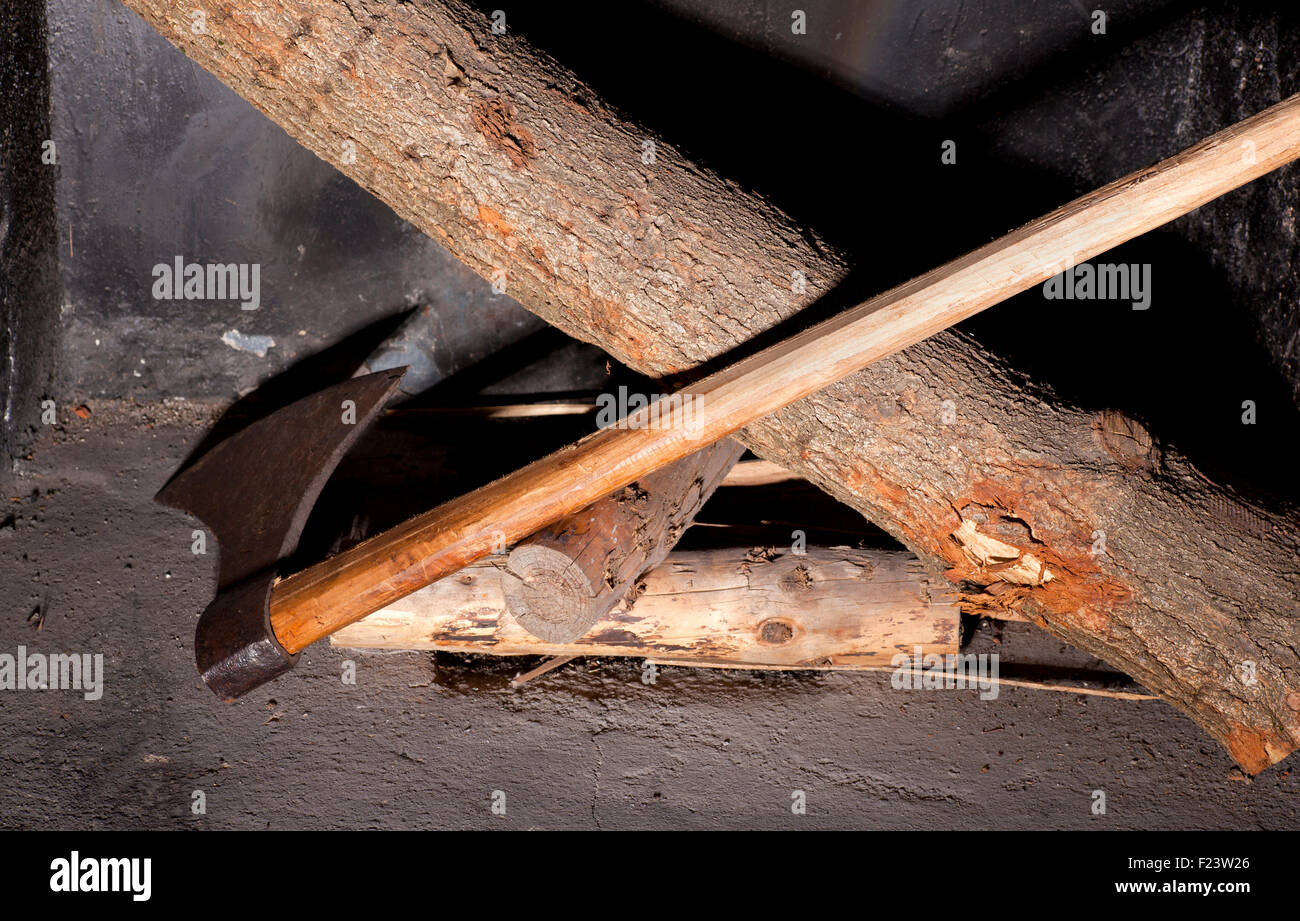 Axe with trunk inside a fireplace Stock Photo - Alamy