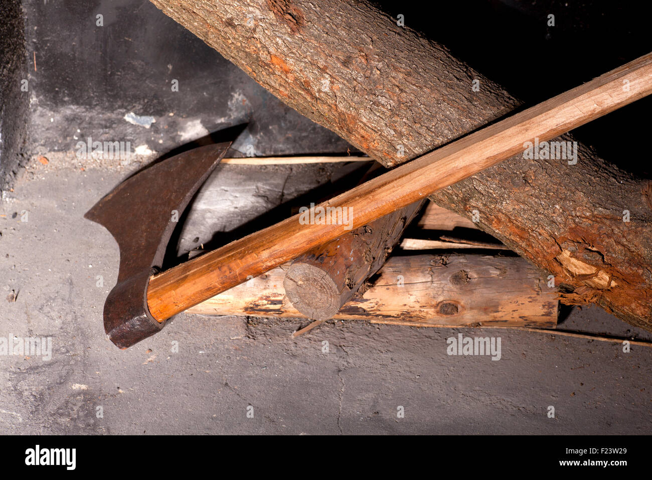 Axe with trunk inside a fireplace Stock Photo - Alamy