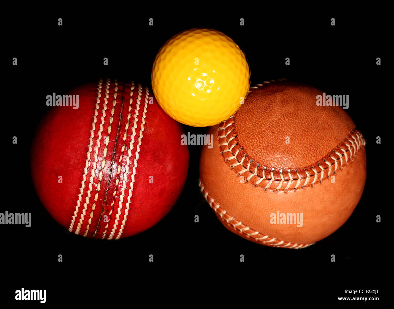 three different sport balls on black background Stock Photo - Alamy
