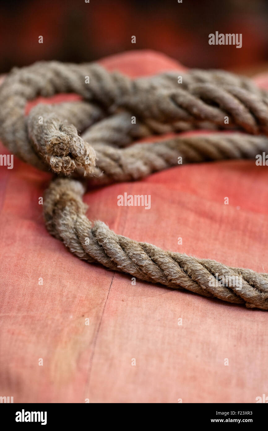 Old rope on red fabric Stock Photo - Alamy