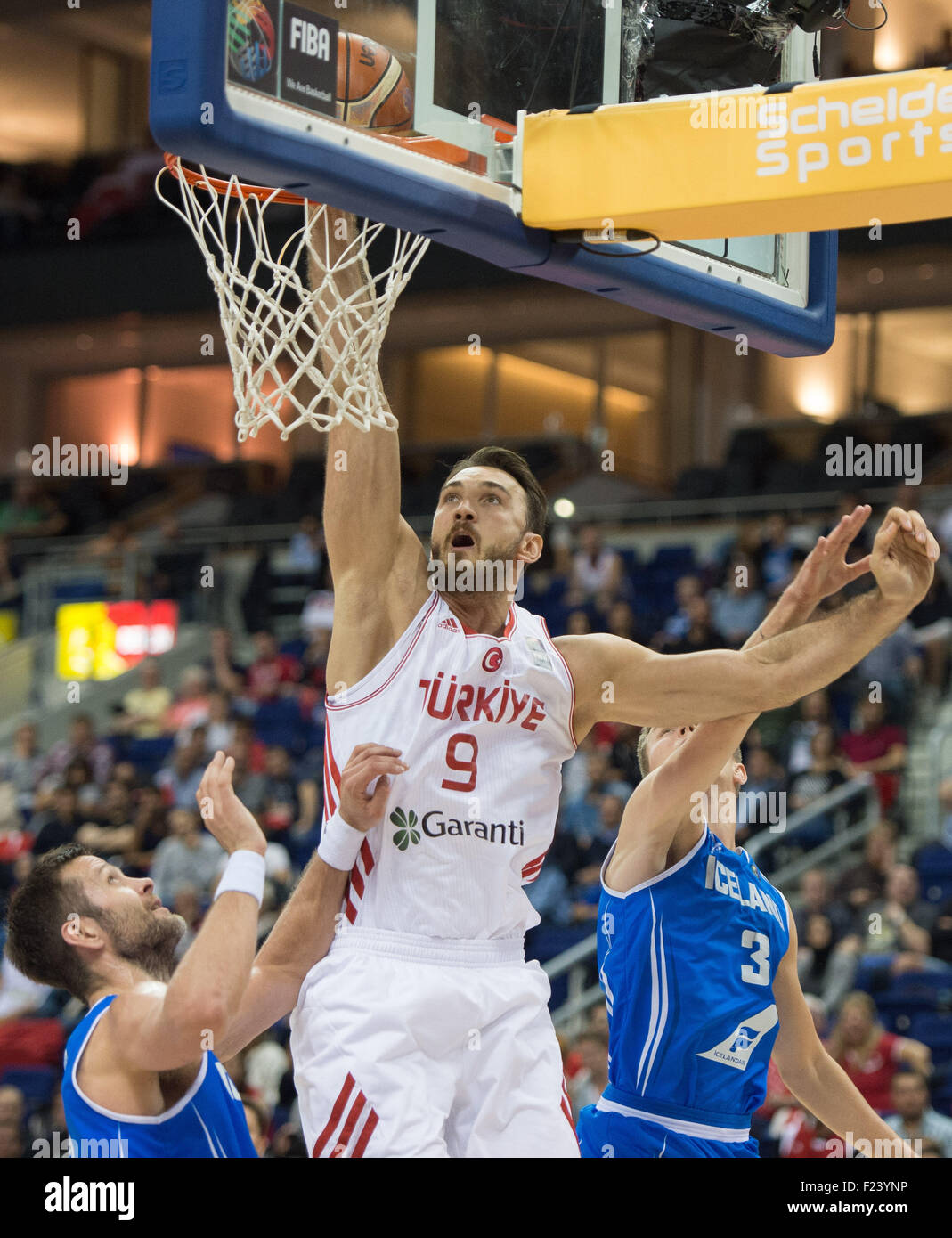 Turkey's Semih Erden (C) and Iceland's Jon Stefansson (L) in action ...