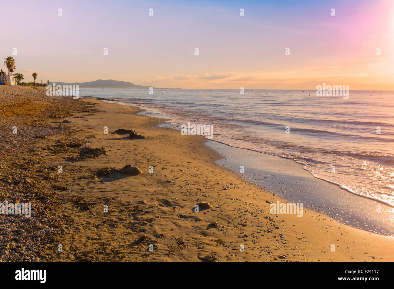 Sunset on the beach Stock Photo - Alamy