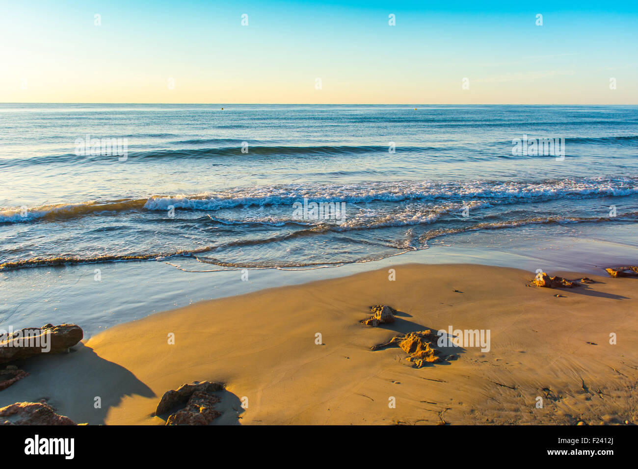 Sunrise on the beach in Spain Stock Photo - Alamy