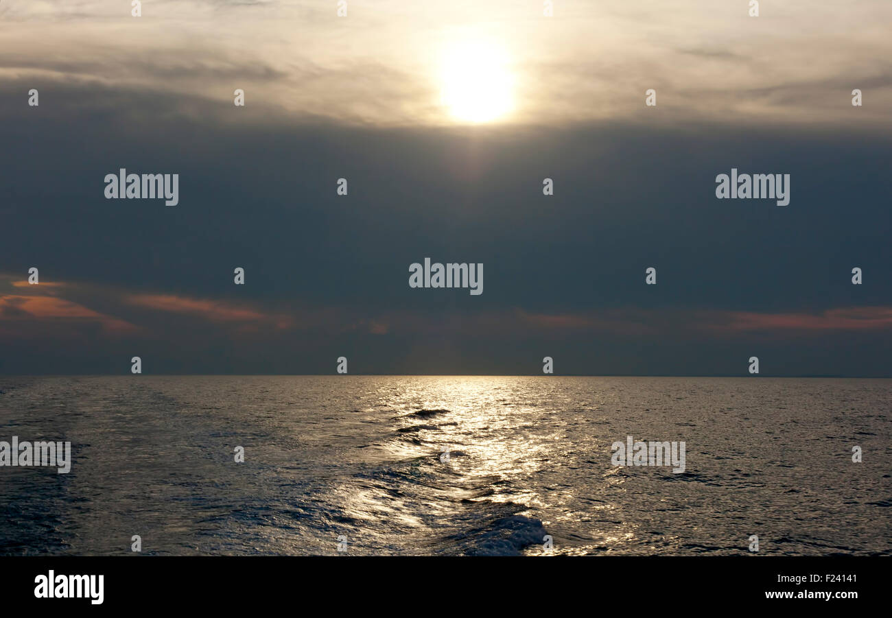 Wake on the sea at sunset Stock Photo - Alamy