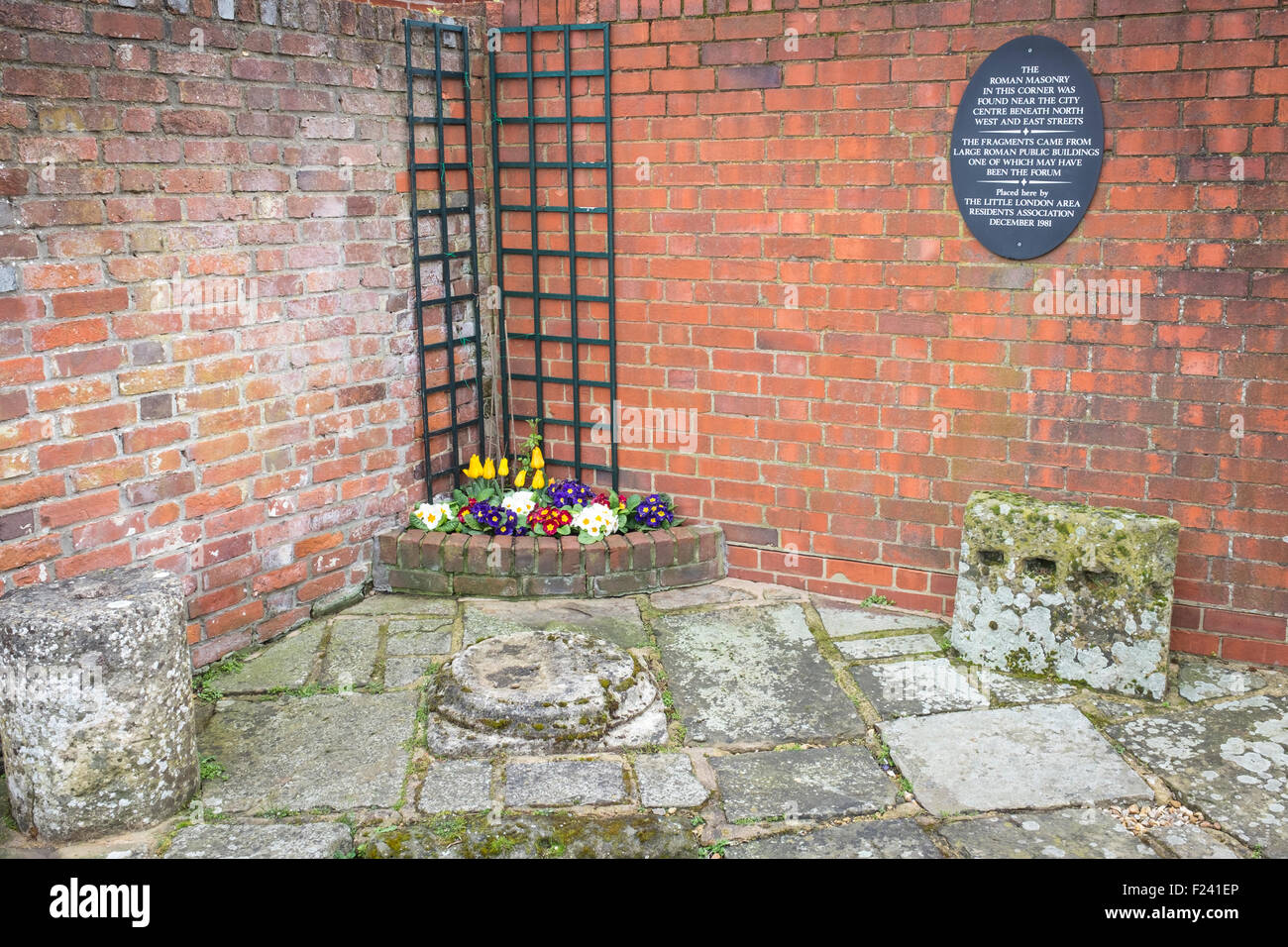 Wall plaque describing origins of the Roman masonry below, Chichester ...