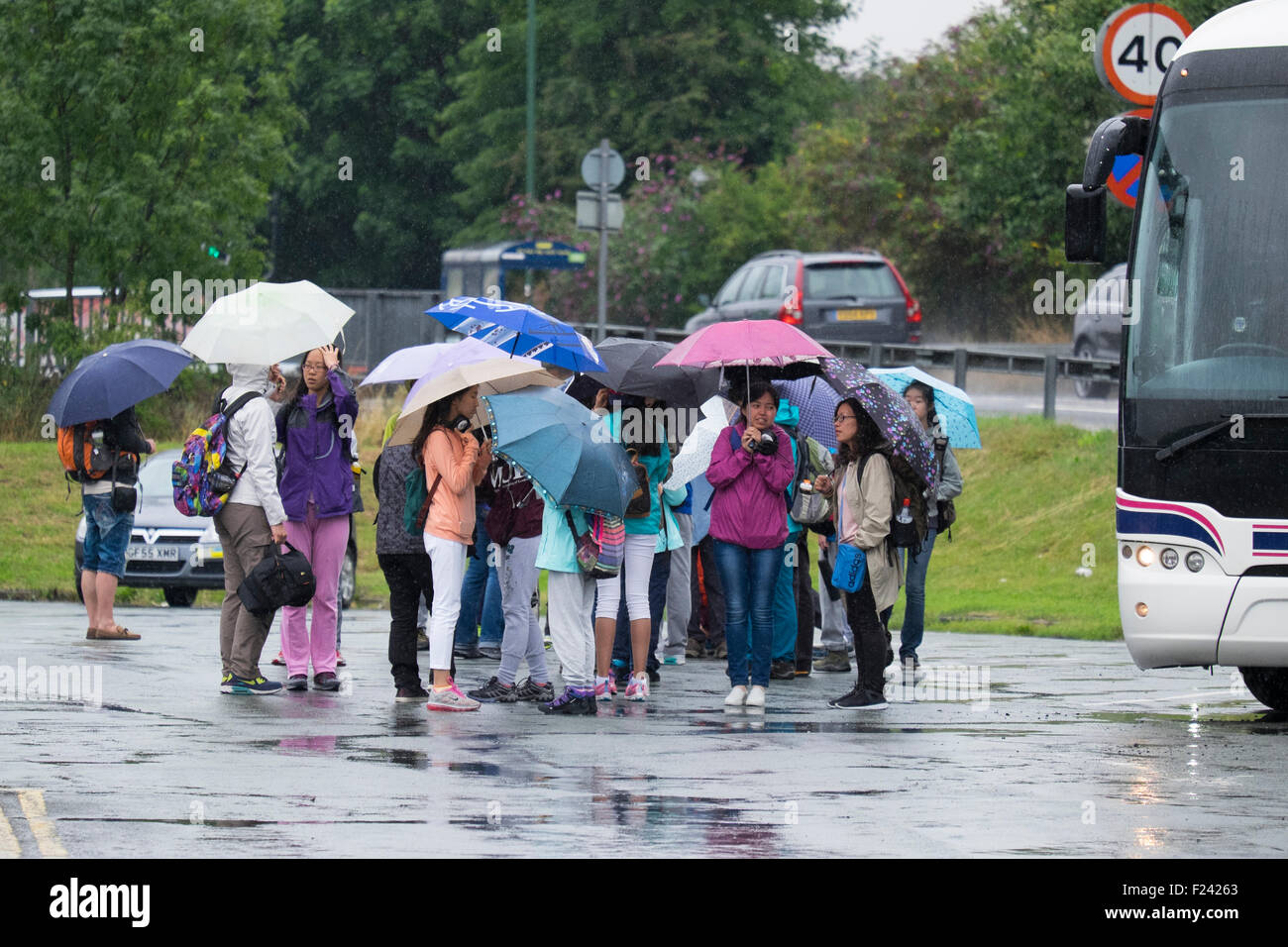 Tourists under umbrellas in pouring rain while visiting Shrewsbury ...