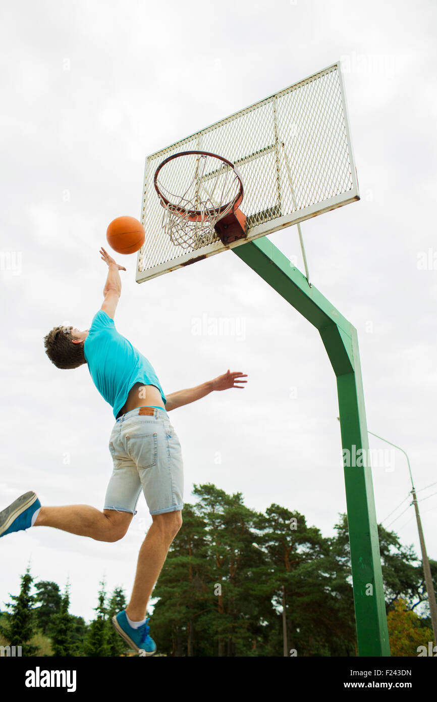 young man playing basketball outdoors Stock Photo - Alamy