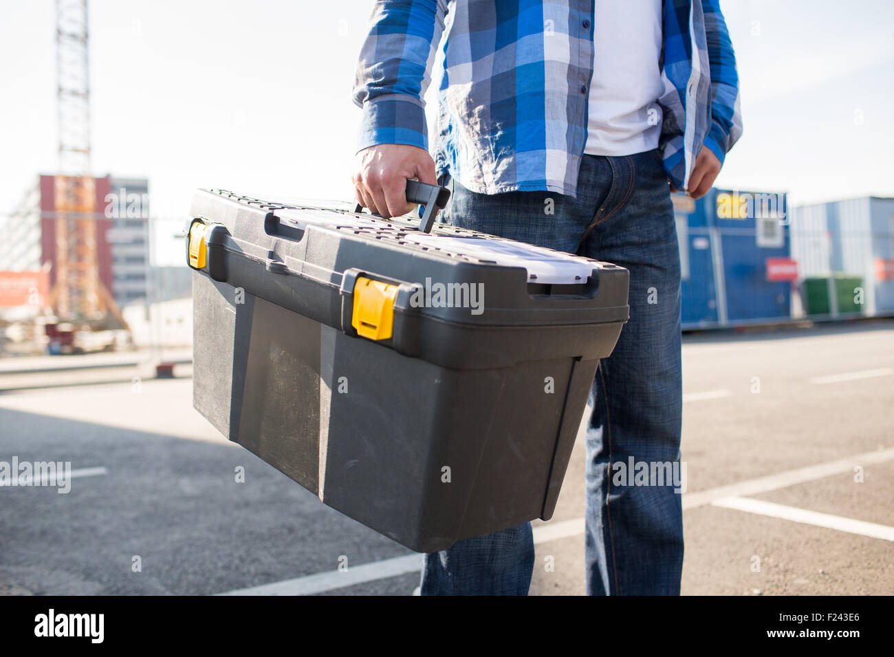 close up of builder carrying toolbox outdoors Stock Photo - Alamy