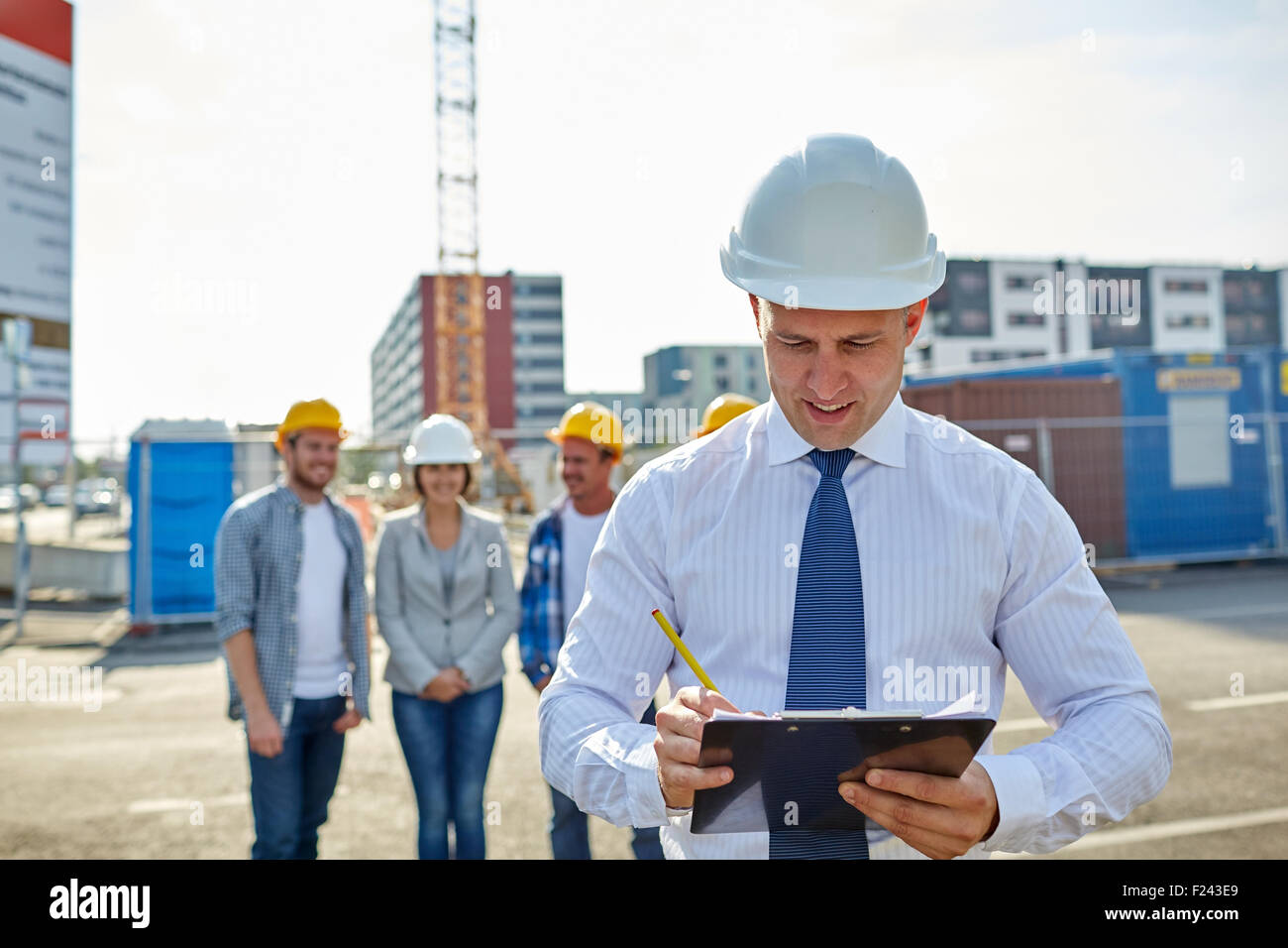 happy builders and architect at construction site Stock Photo - Alamy