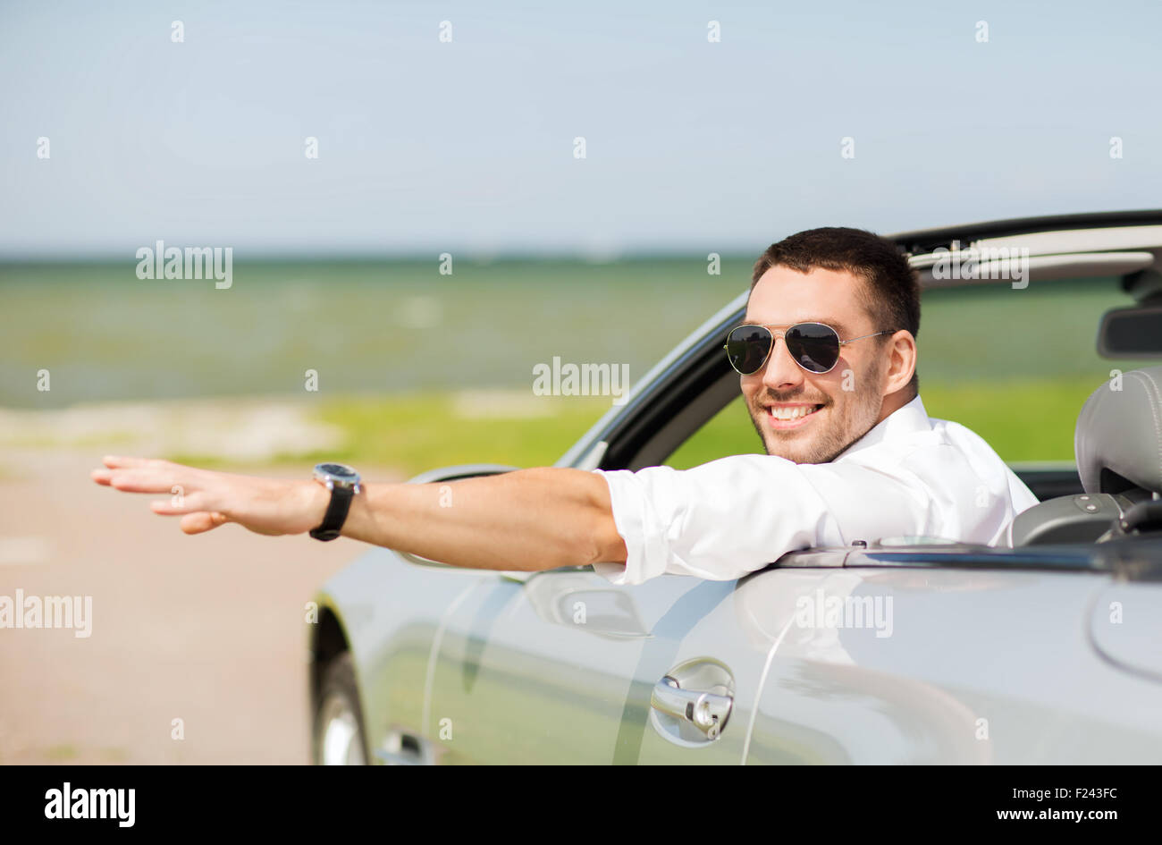 happy man driving cabriolet car and waving hand Stock Photo - Alamy
