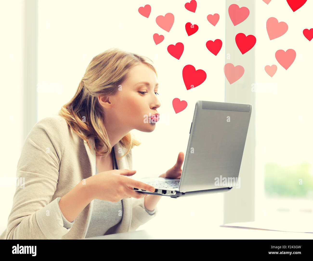 Young woman kissing computer monitor hi-res stock photography and ...