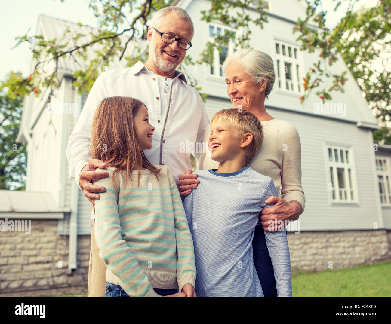 happy family in front of house outdoors Stock Photo - Alamy