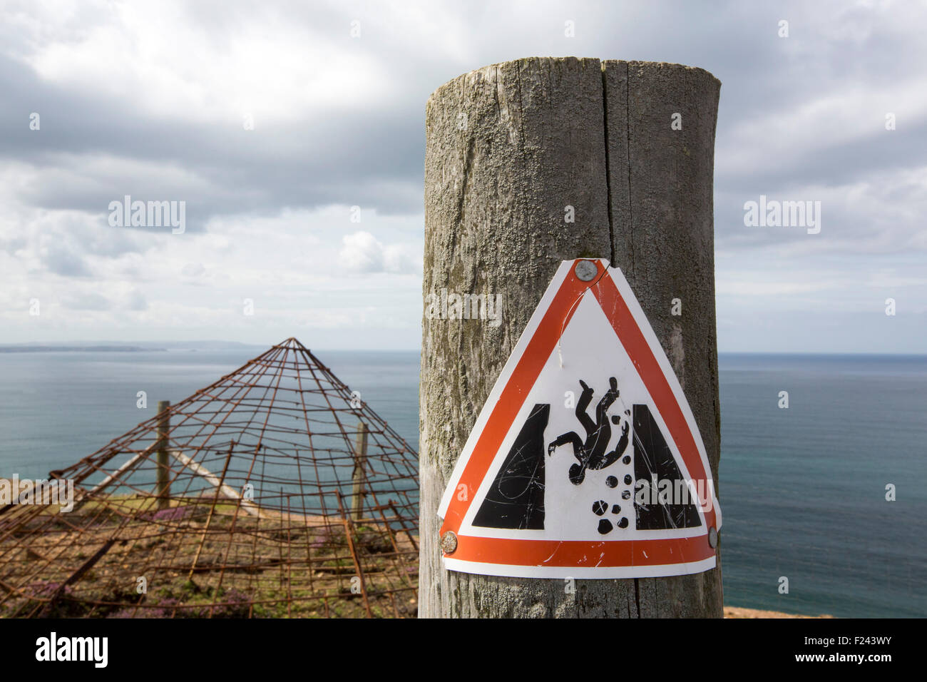 A warning sign by an old abandoned tin mine shaft on the cliffs at St ...