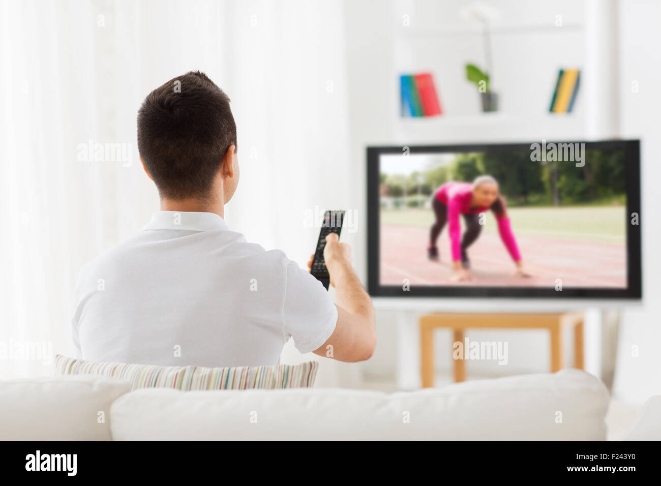 man watching sport channel on tv at home Stock Photo - Alamy