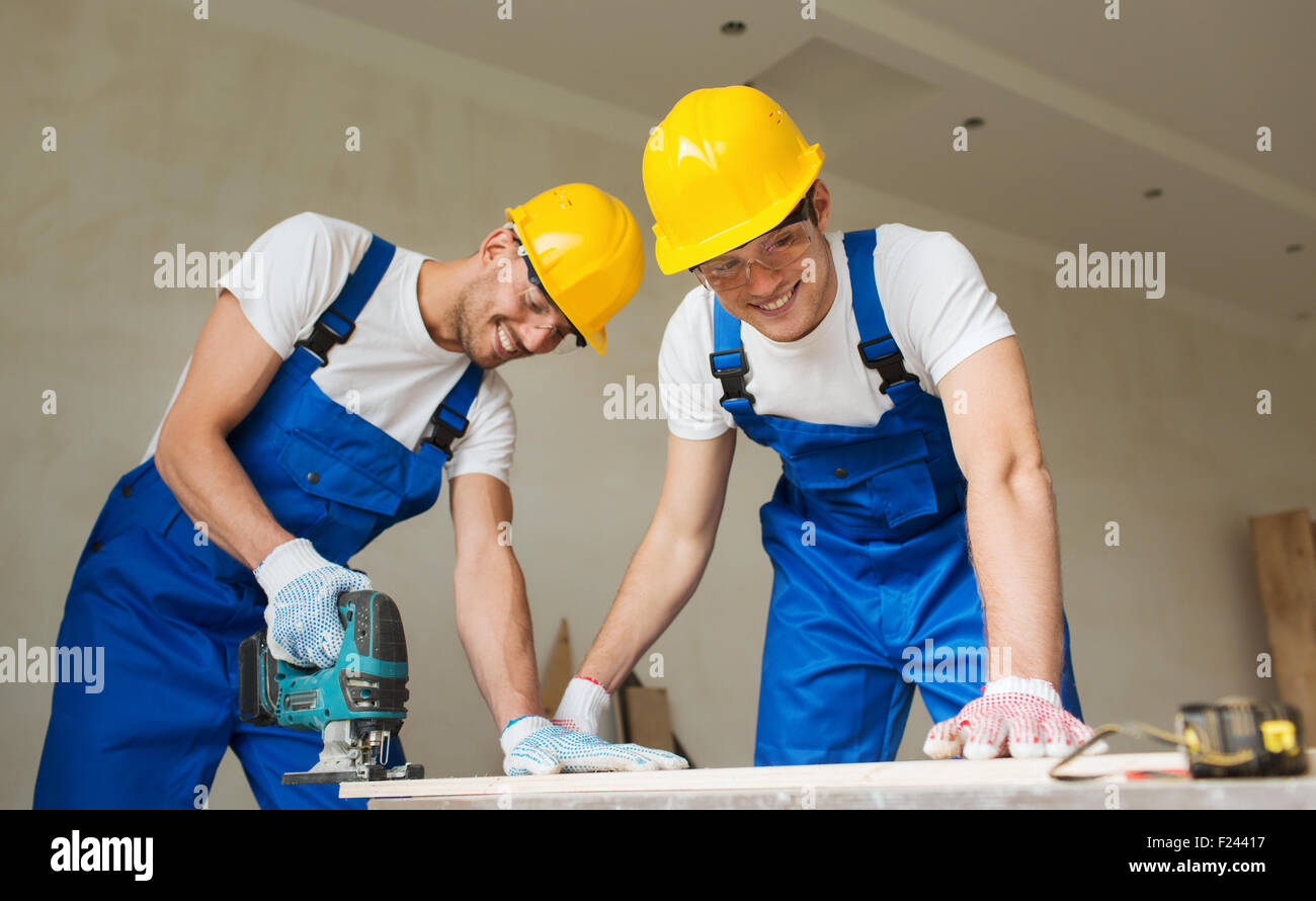 group of builders with tools indoors Stock Photo - Alamy