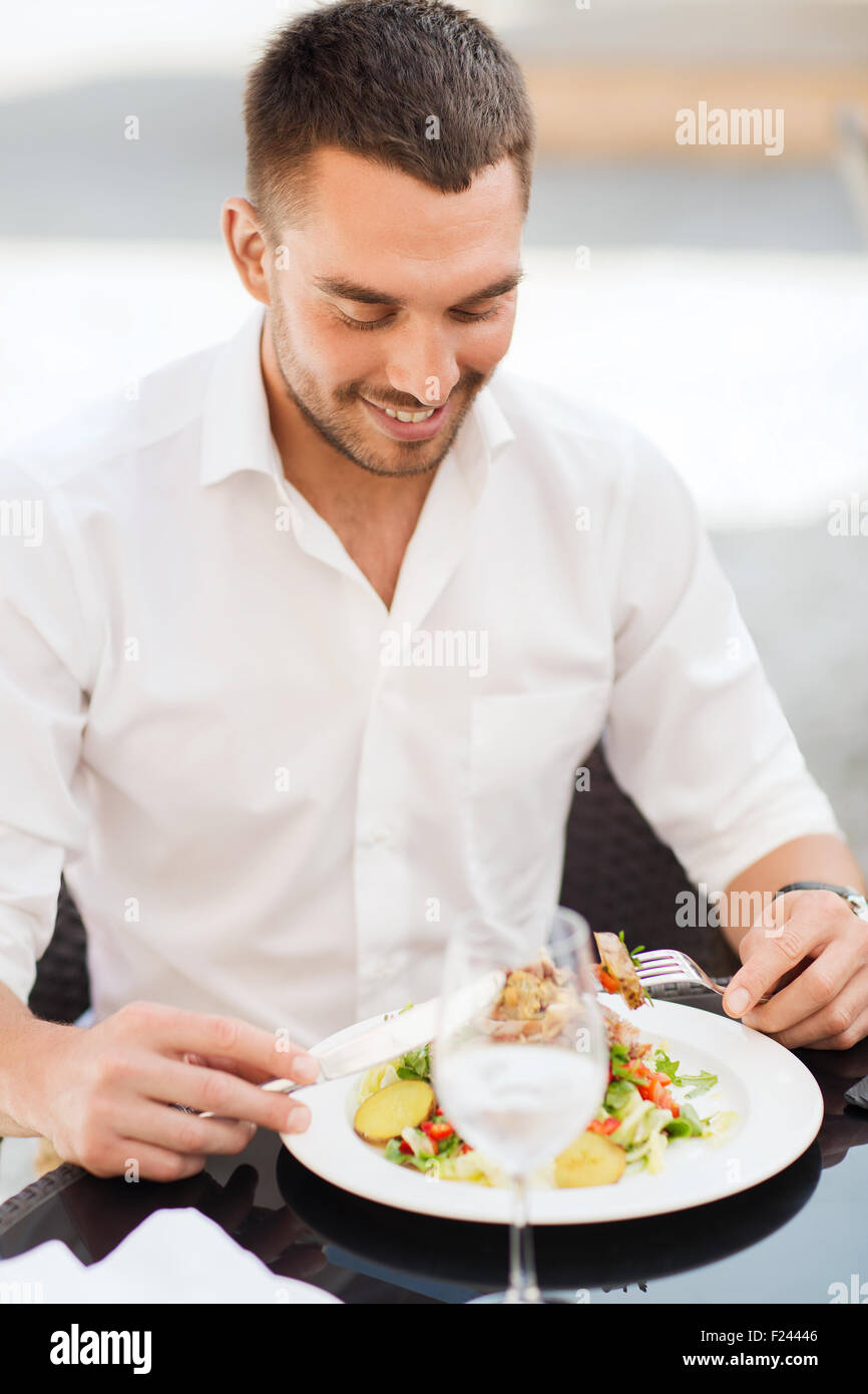 happy man eating salad for dinner at restaurant Stock Photo - Alamy