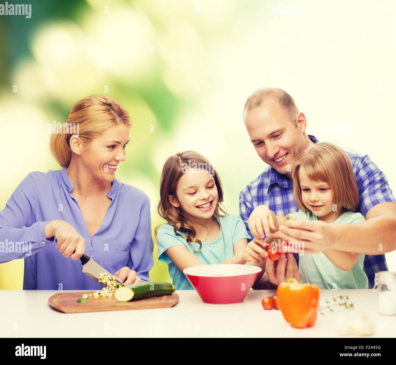 happy family with two kids making dinner at home Stock Photo - Alamy