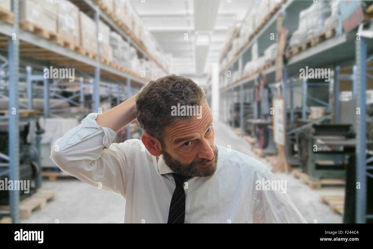worried man at work in a storage space Stock Photo - Alamy